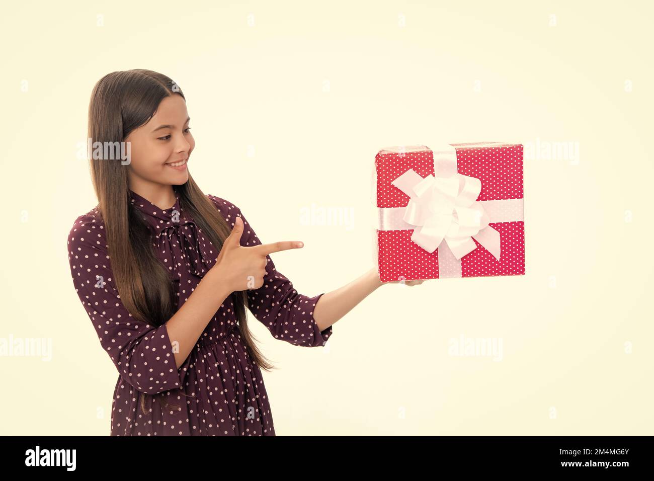 Child with gift present box on isolated studio background. Gifting for ...