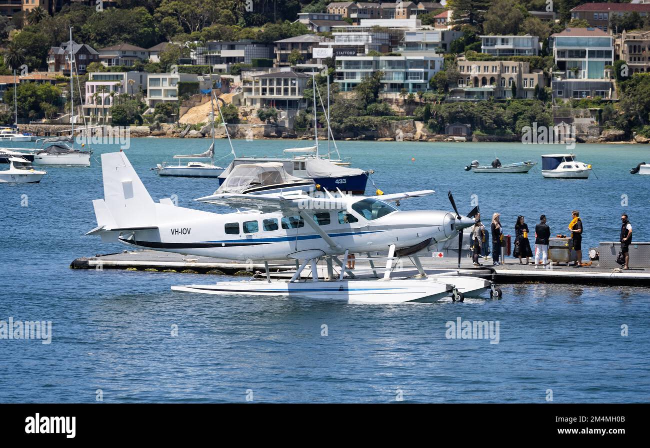 Close up of white seaplane docked at pier to embark passengers at ...