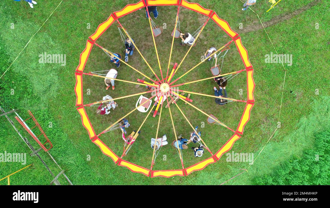 Carnival Merry Go Round aerial top view. Drone tracking rotation shoot ...