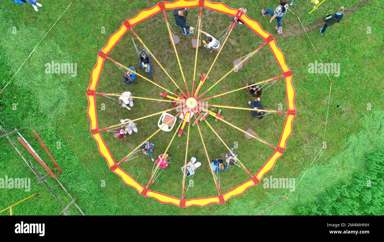Carnival Merry Go Round aerial top view. Drone tracking rotation shoot ...