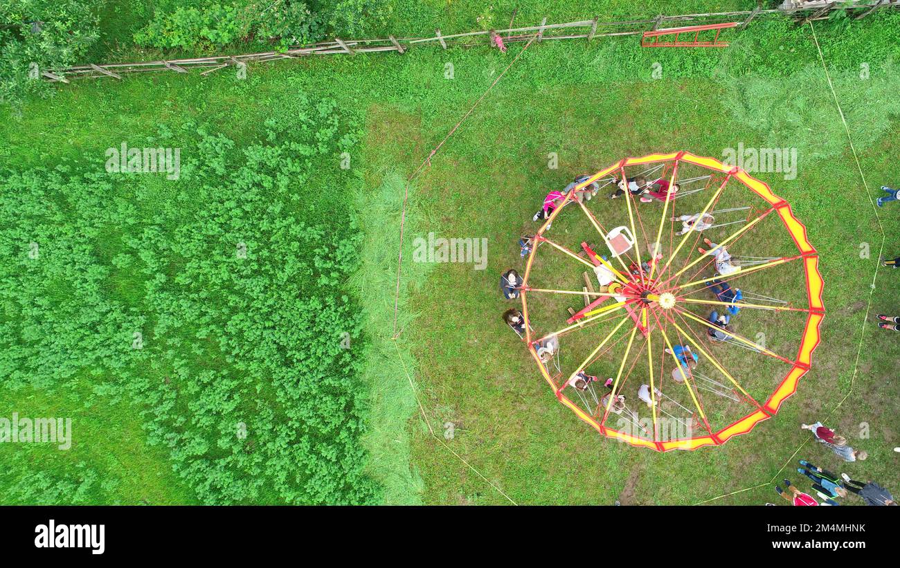 Carnival Merry Go Round aerial top view. Drone tracking rotation shoot ...