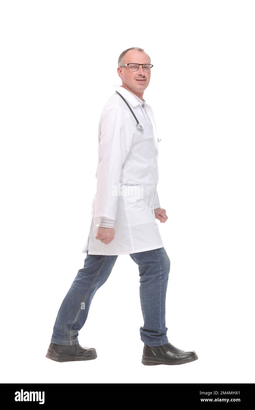 Middle age doctor with stethoscope walking on white background Stock ...