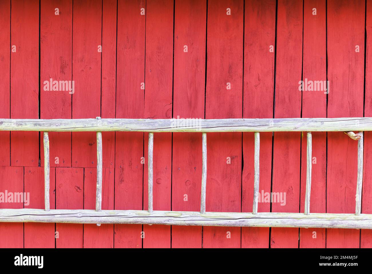Old wooden ladder on a red wooden wall Stock Photo - Alamy