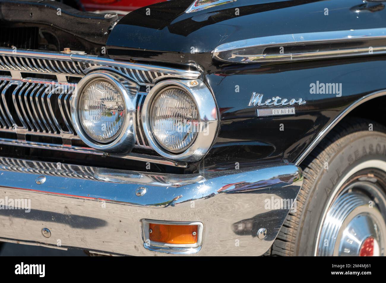 The front and headlight of blue vintage Mercury Meteor car at a show ...