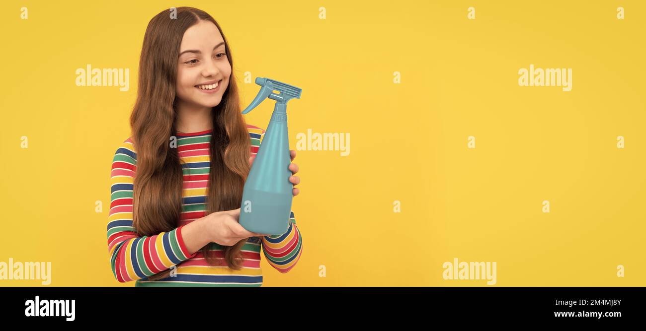 Happy kid hold disinfectant spraying bottle for copy space yellow ...