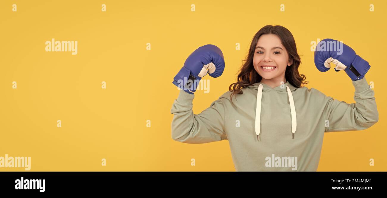 happy child in boxing gloves on yellow background. Horizontal poster of ...
