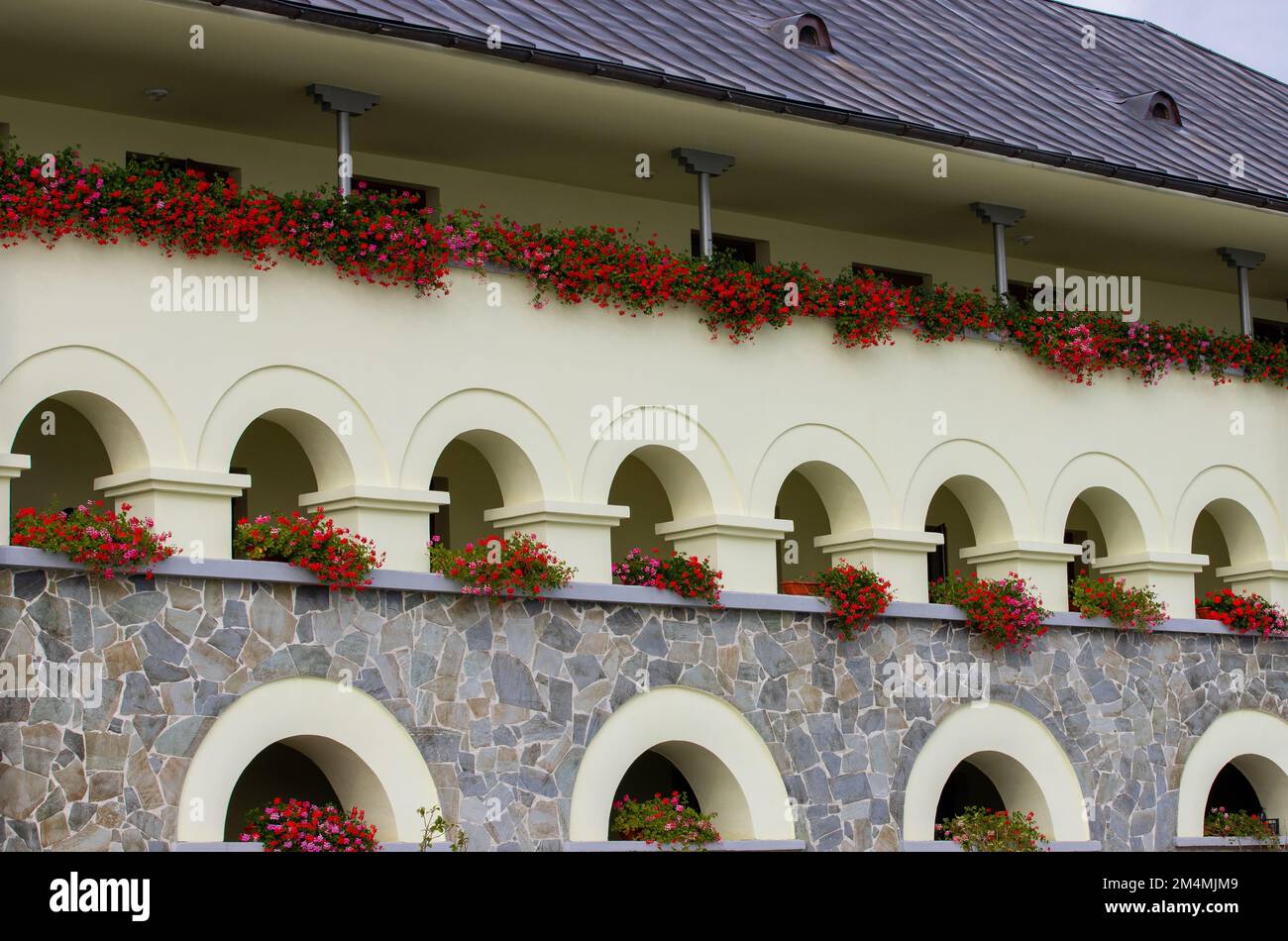 The beautiful facade of a building with flowers and arches Stock Photo ...