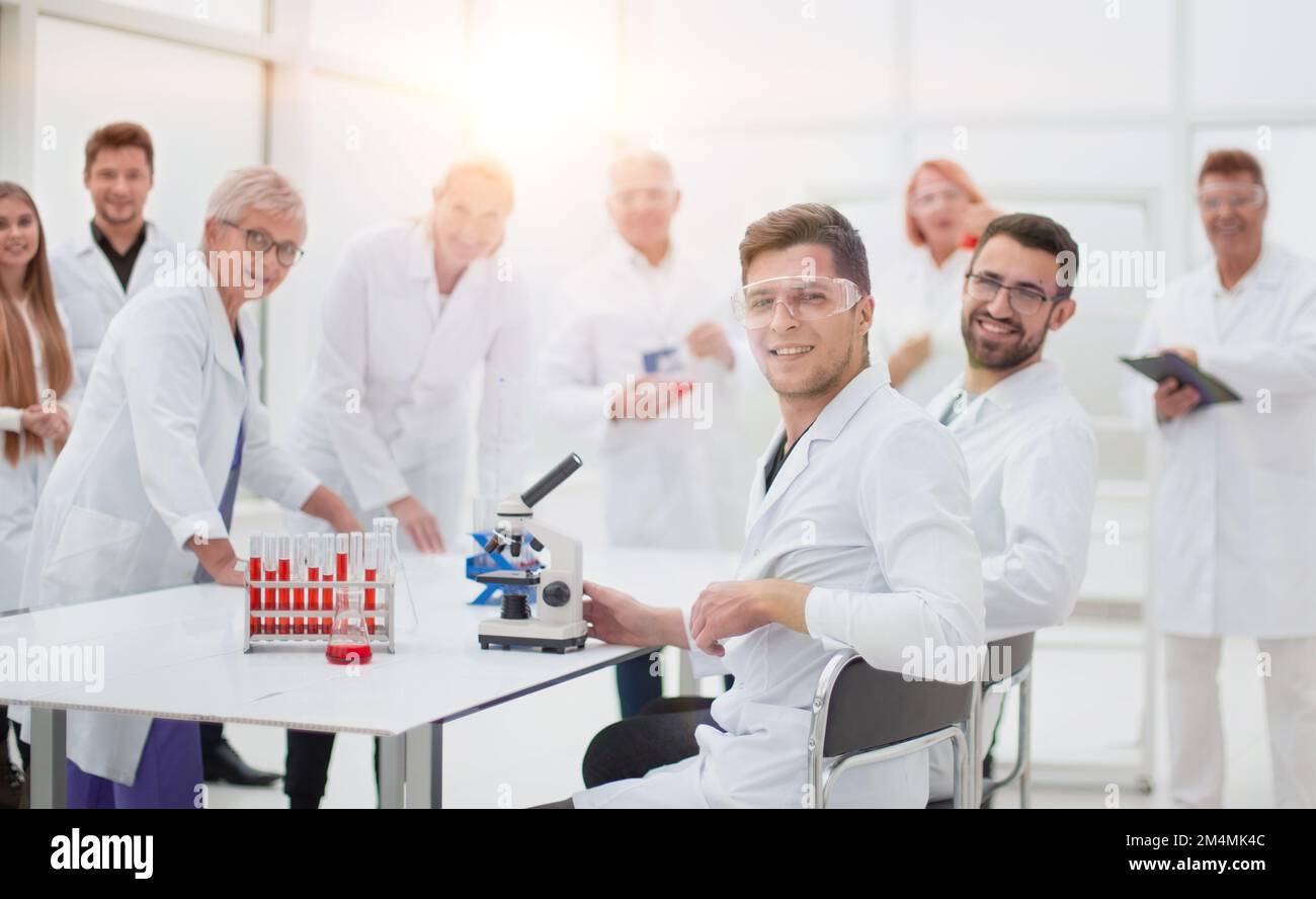 young scientist and his colleagues work in the laboratory Stock Photo ...