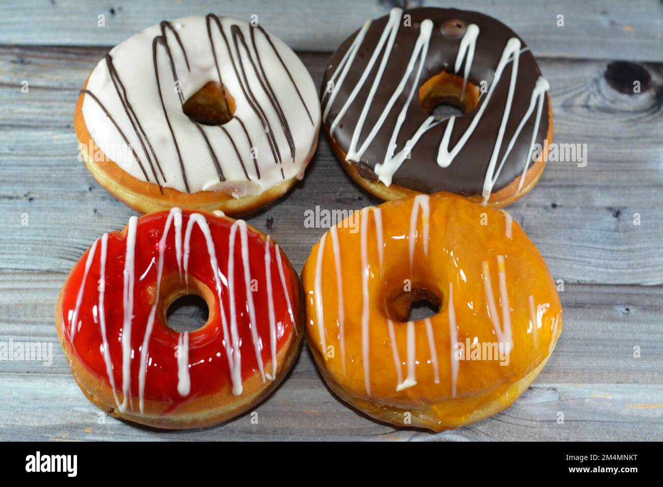 Ring donuts with brown and white chocolate and strawberry and mango ...