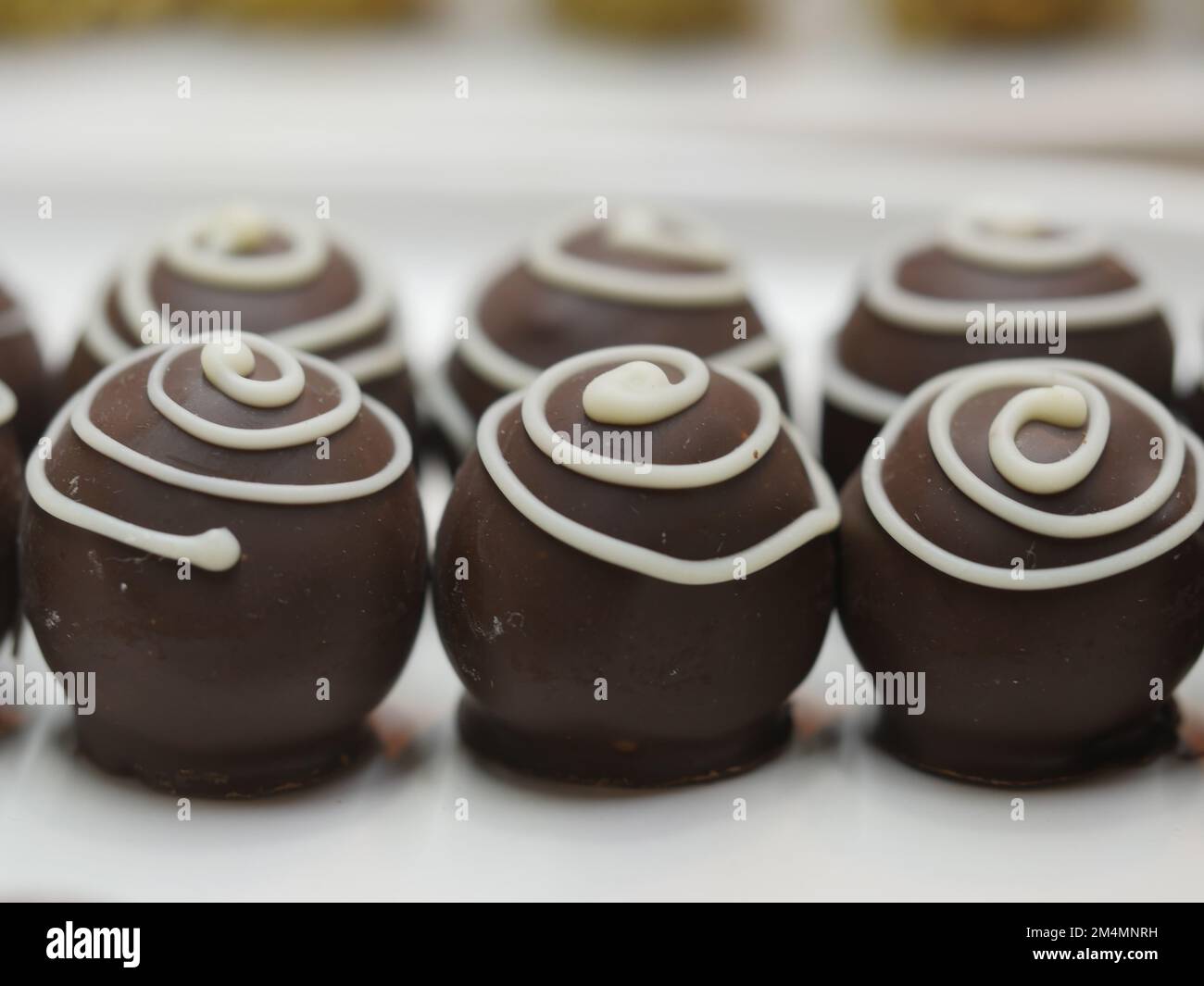 handmade pralines from chocolate on display Stock Photo - Alamy