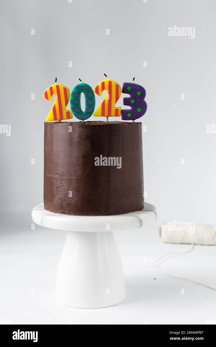 2023 cake, new year cake, chocolate ganache cake on a cake stand Stock Photo - Alamy