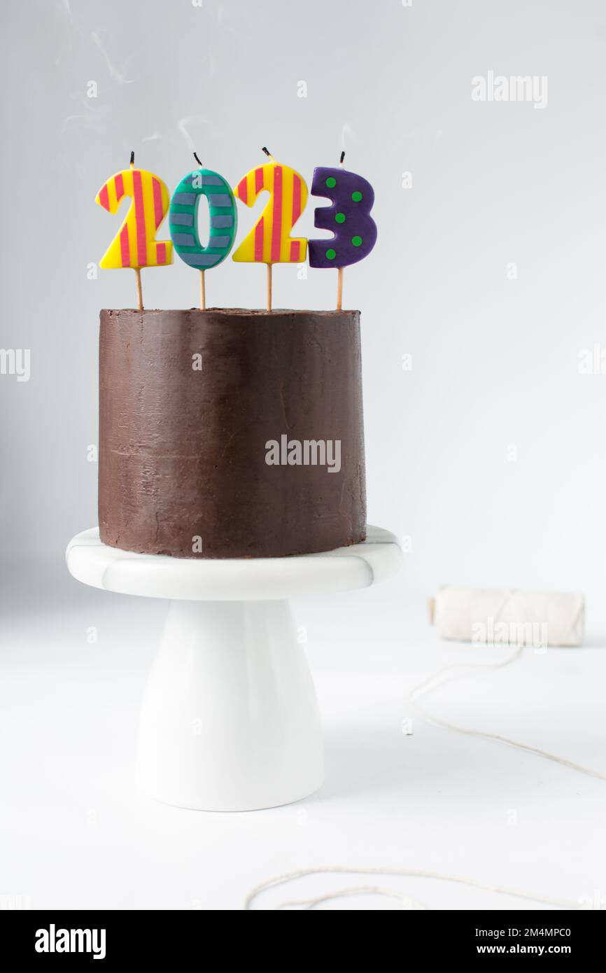 2023 cake, new year cake, chocolate ganache cake on a cake stand Stock Photo - Alamy