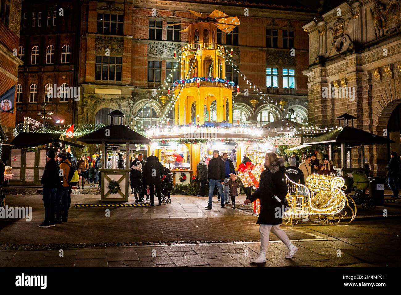 People walk between trading stalls during a fair. The Gdansk Christmas ...