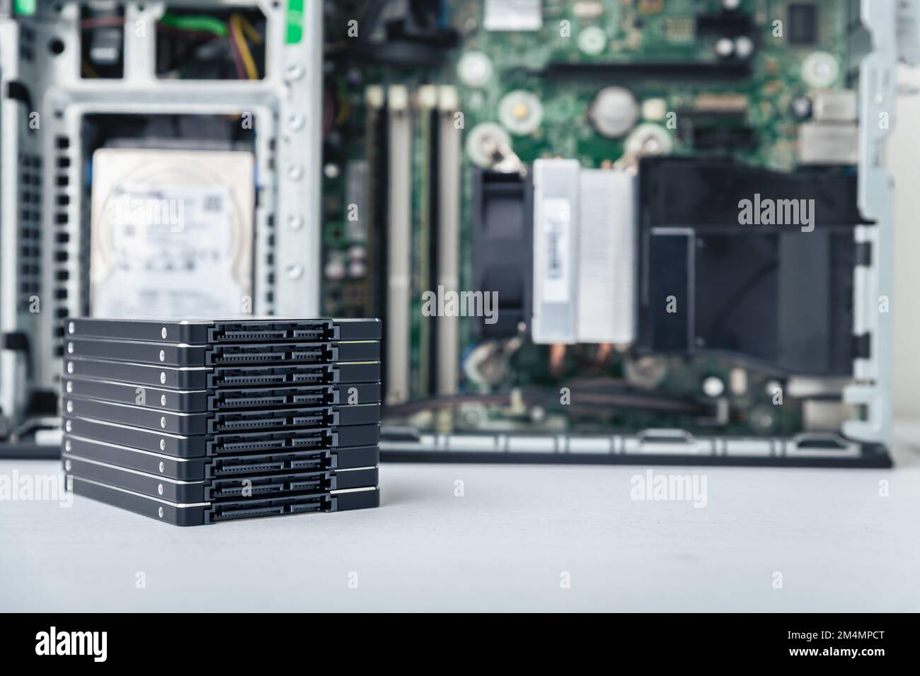 Closed-up view of SSD hard disk drives with a PC in the background ...