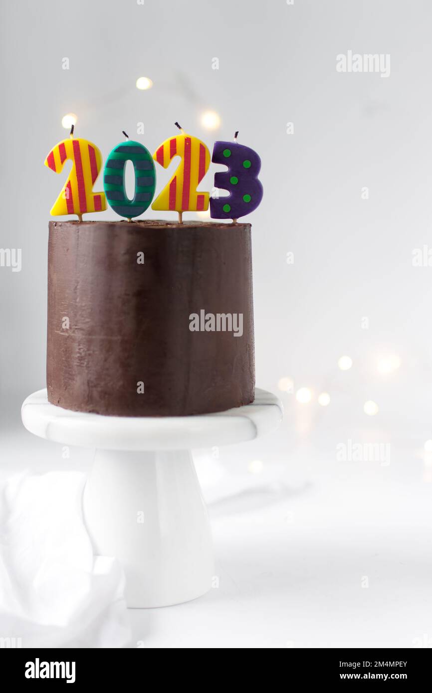 2023 cake, new year cake, chocolate ganache cake on a cake stand Stock Photo - Alamy