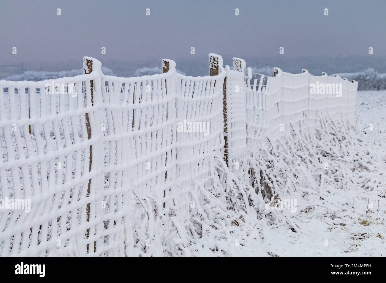 A fence white with snow in a rural area in cold winter, Germany Stock ...