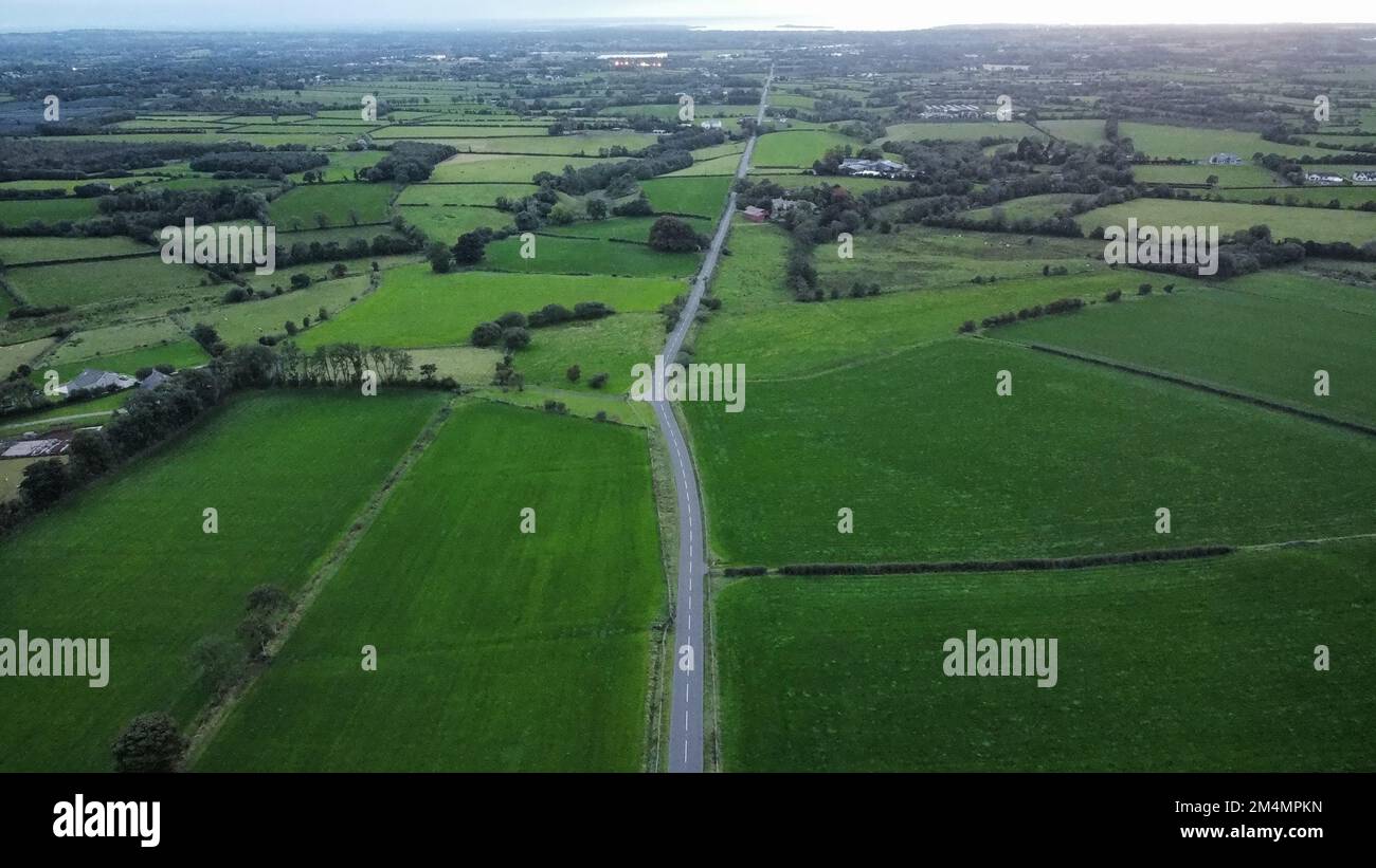 A bird's eye view of a highway in a green landscape of agricultural ...