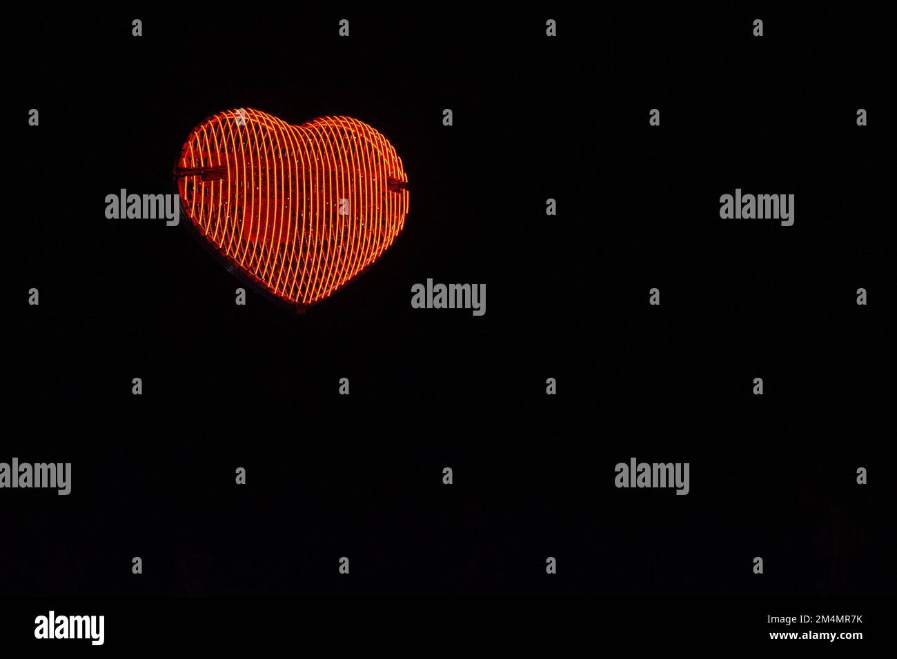 A low-key shot of the heart shape Christmas light decorations on a dark ...