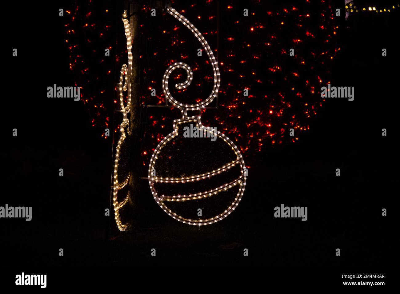 A low-key shot of the Christmas light decorations on a dark sky ...