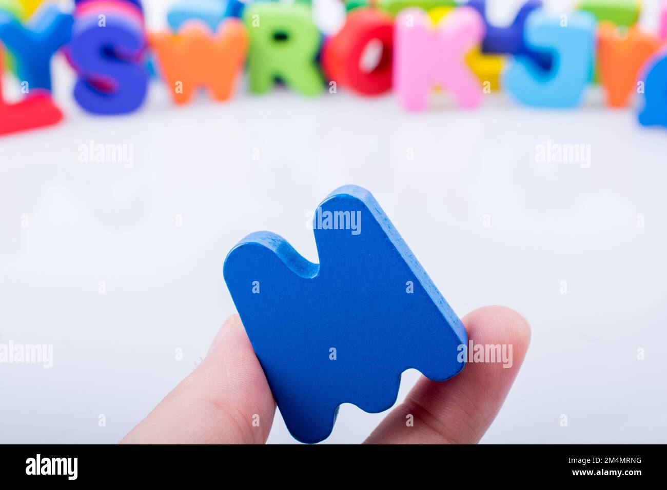 Hand holding letter cube M of made of wood Stock Photo - Alamy