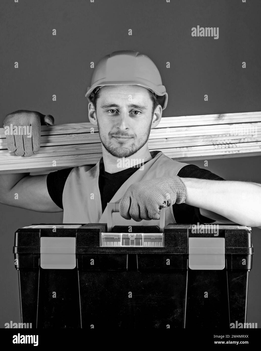 Man In Helmet Hard Hat Holds Toolbox And Wooden Beams Grey Background Professional Woodworker