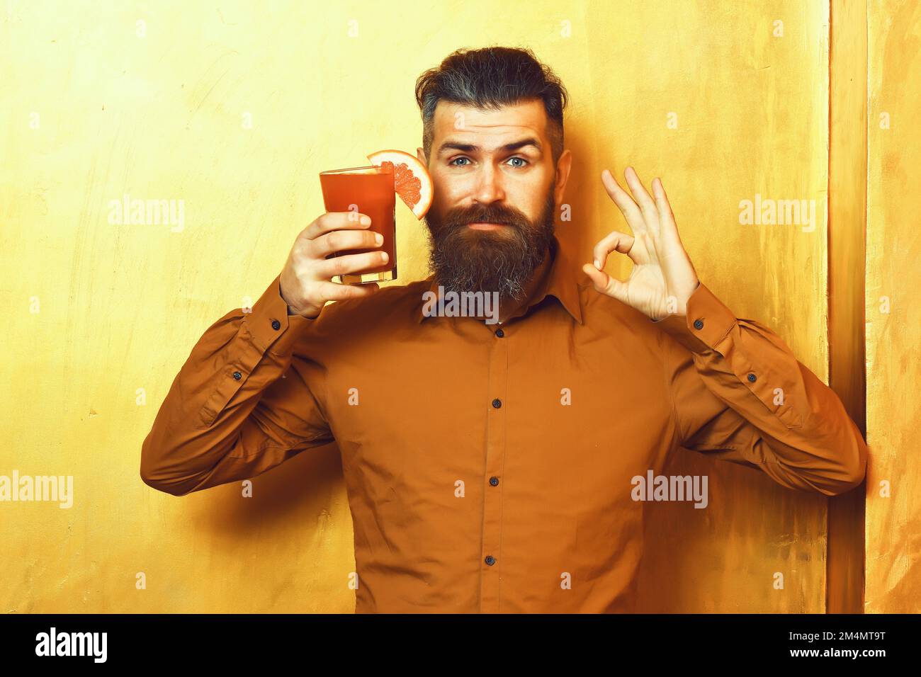 Brutal caucasian hipster holding tropical alcoholic fresh cocktail ...