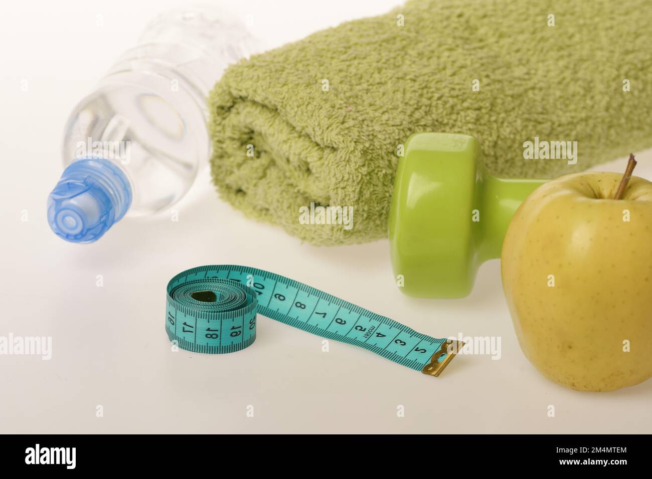 Dumbbell in green color, water bottle, measure tape, towel, fruit Stock ...