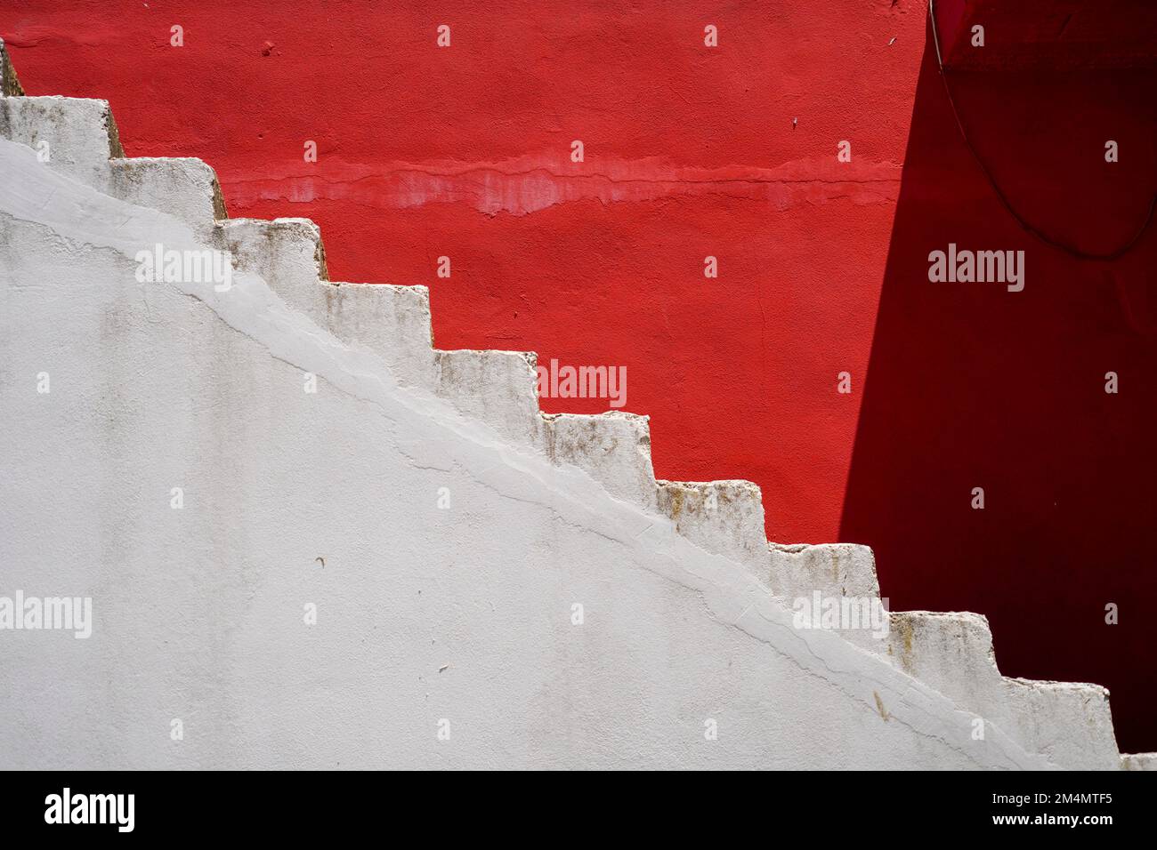 Red and white abstract zigzag staircase with a partial dark shade Stock ...