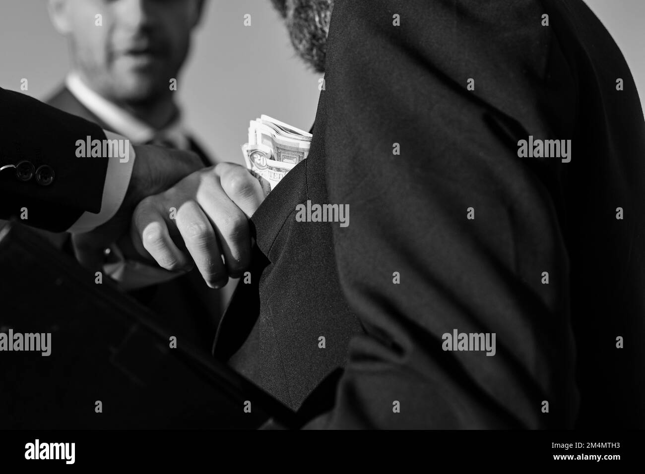 Manager puts money into pocket on blue sky background Stock Photo - Alamy