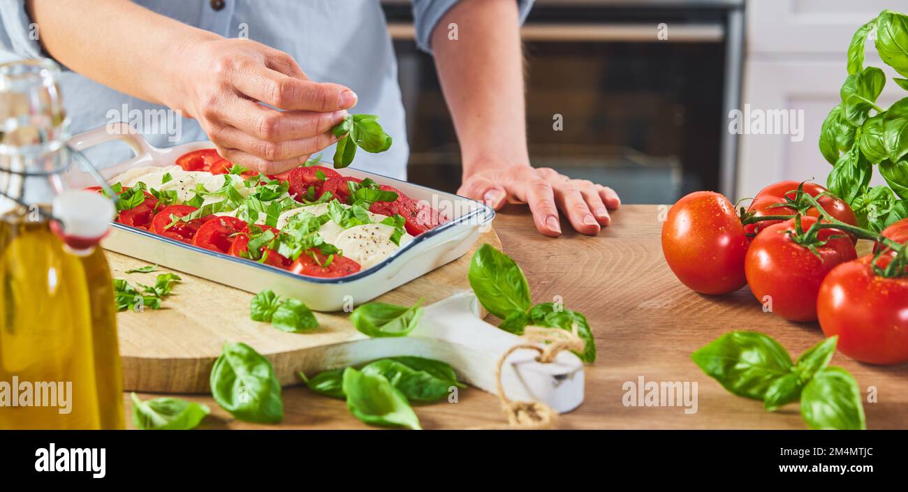 High angle of crop unrecognizable female cook standing near wooden ...