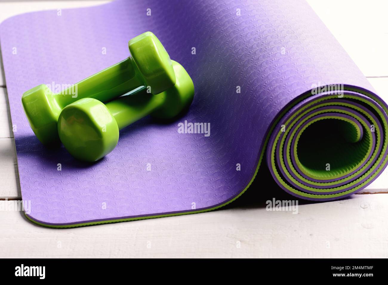 Barbells lying on purple yoga mat. Sports and healthy lifestyle Stock ...