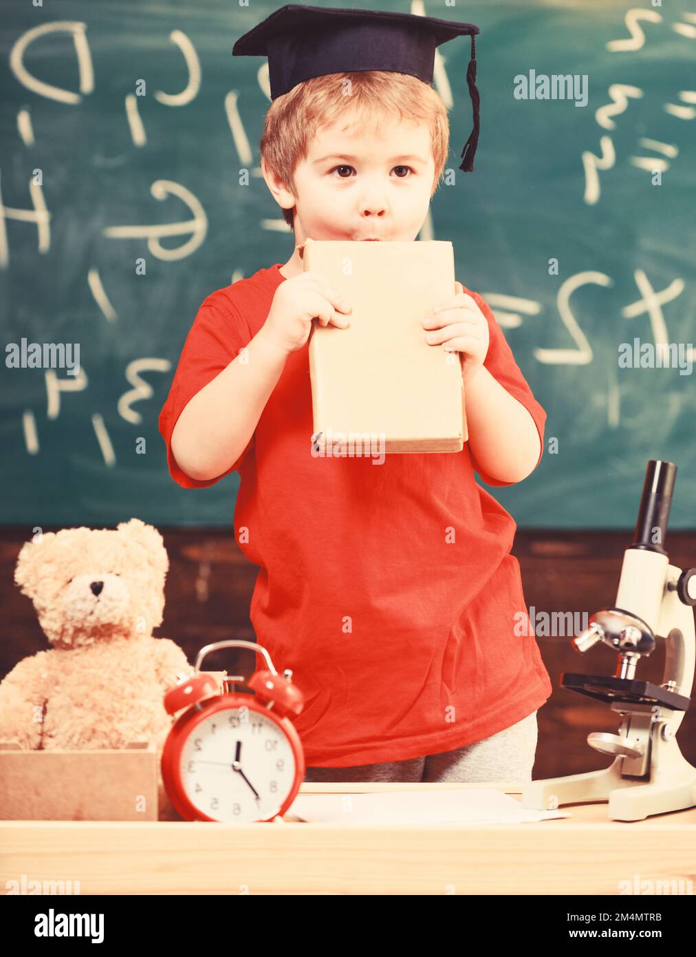 Child, pupil on cheerful face near microscope. Wunderkind concept. Kid ...