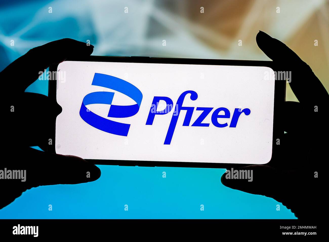In this photo illustration, a Pfizer logo seen displayed on a ...