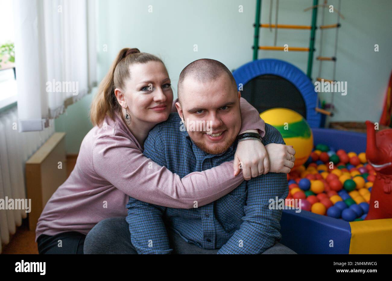 caring mom hugs a child diagnosed with autism in a rehabilitation ...