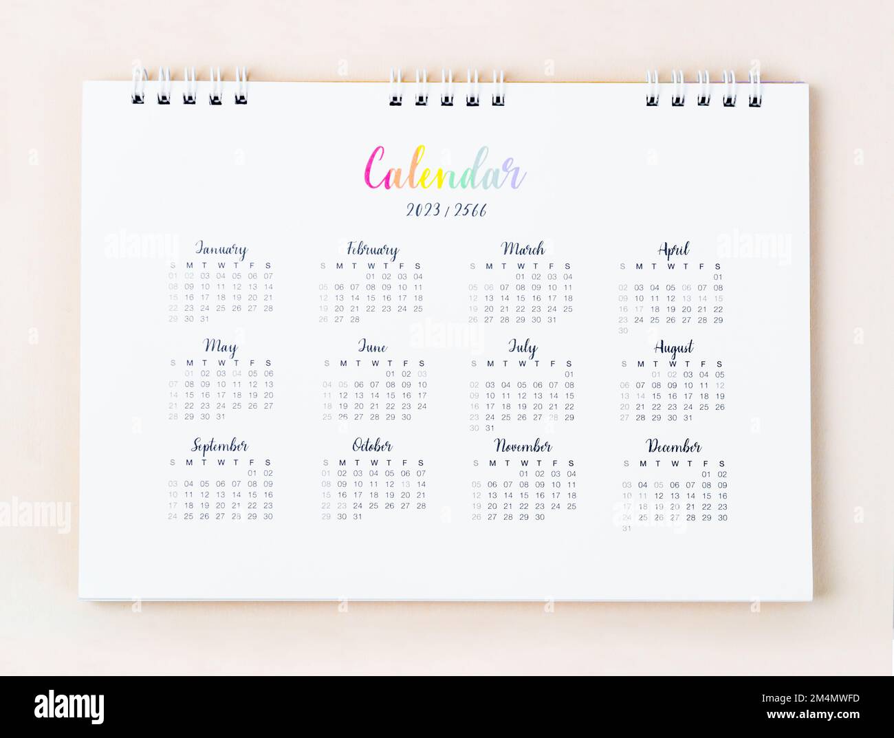 12 months desk calendar for 2023 year on a yellow background planning ...