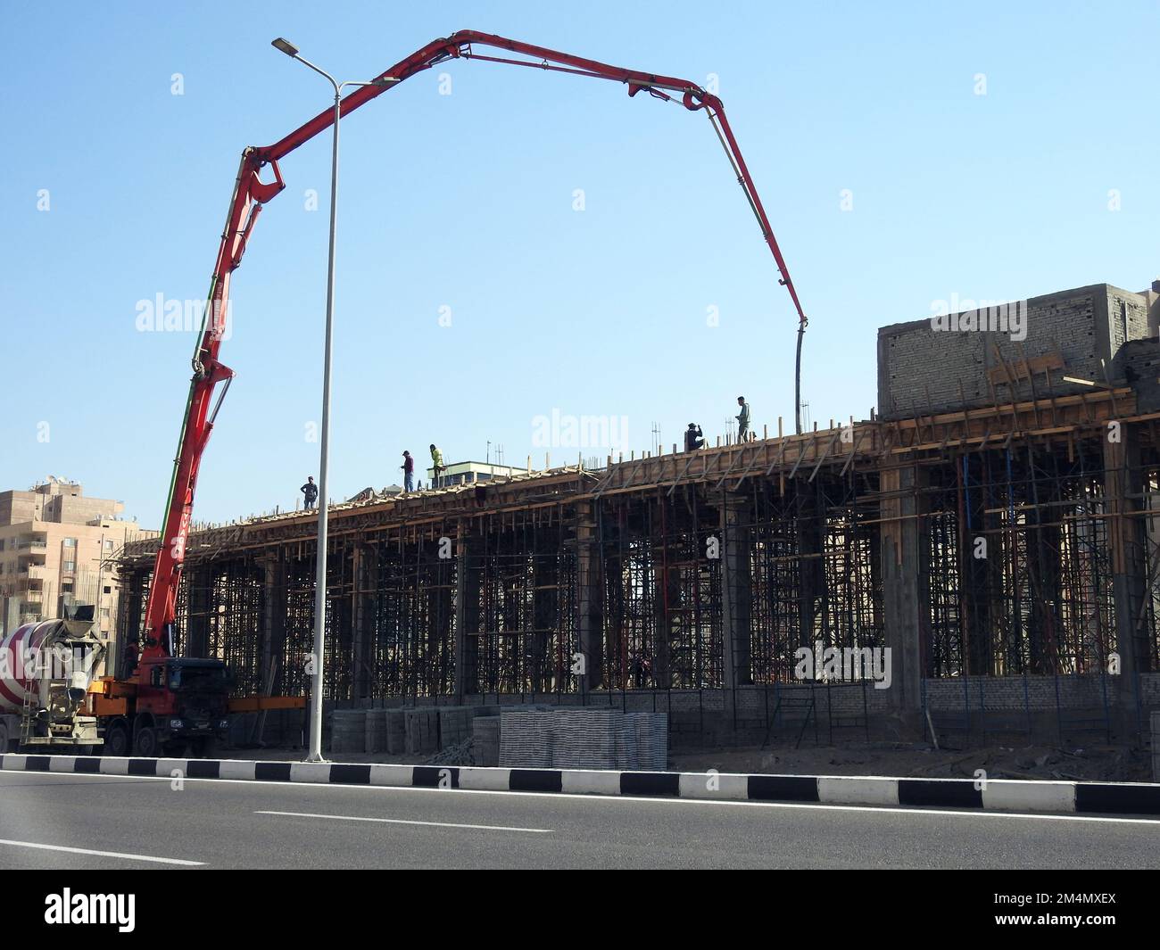 Cairo, Egypt, November 30 2022: A truck-mounted concrete boom pump at the side of the road ...