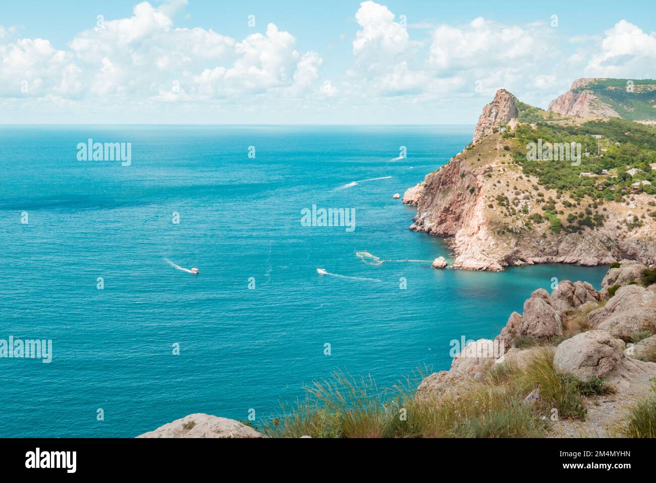 A high sheer cliff, beautiful blue sea and sky Stock Photo - Alamy