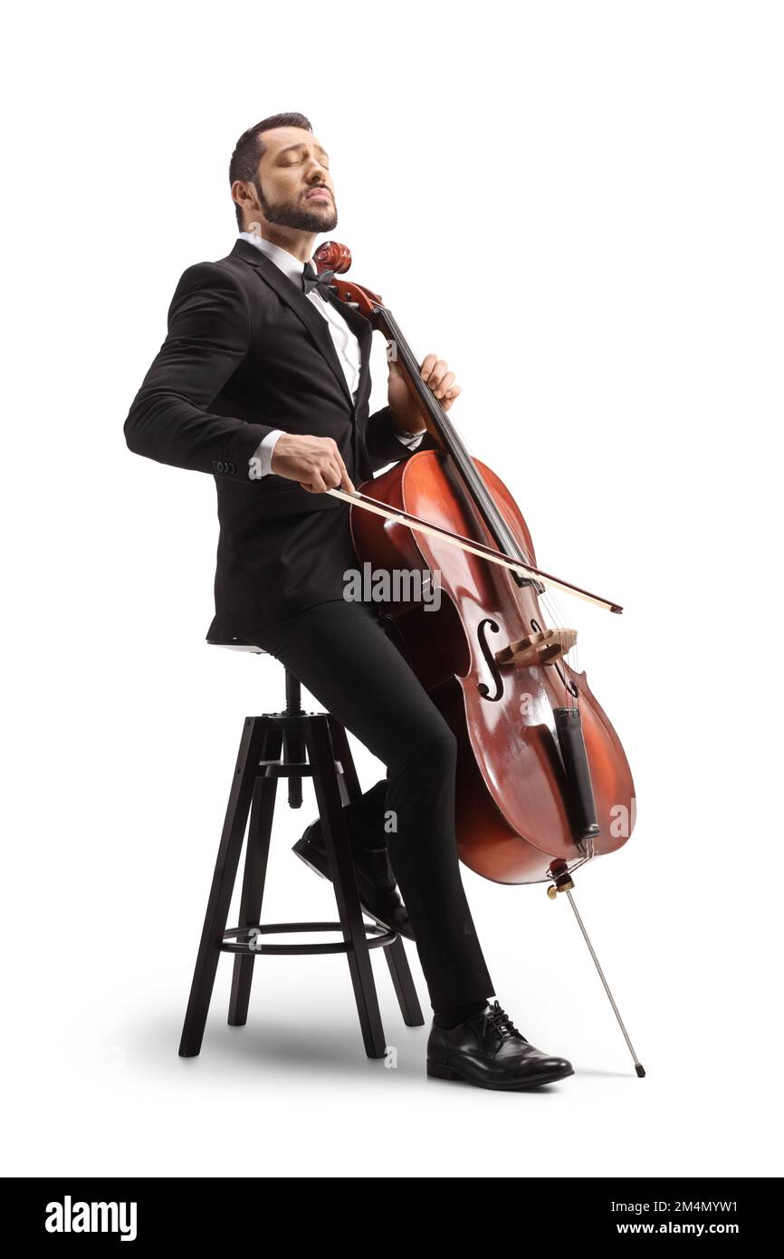 Male musician in a black suit and bow-tie sitting on a chair and ...