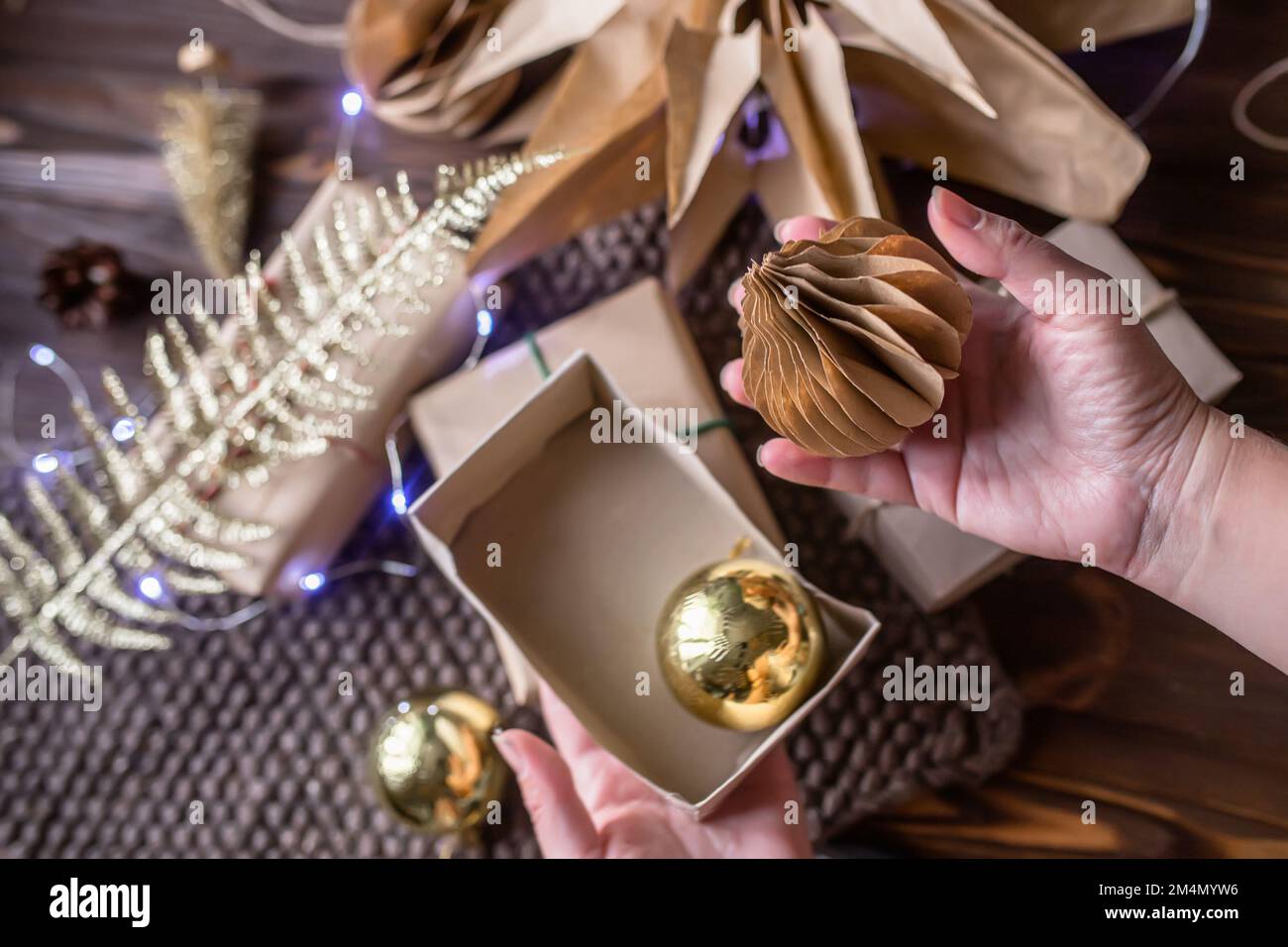 Hand holding a handmade toy made of craft paper. Zero waste concept ...