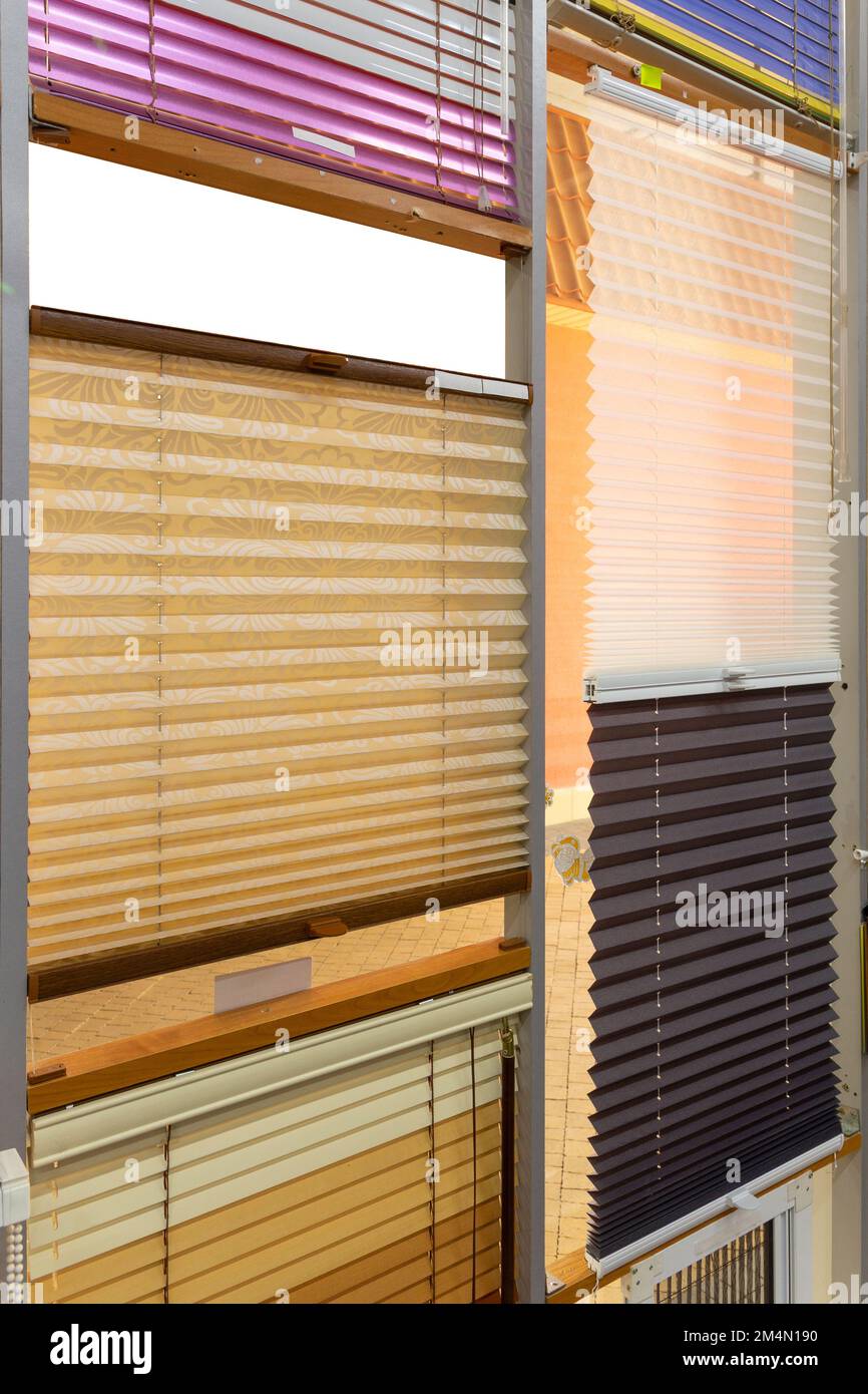 Samples of blinds for windows in the store. Plastic blinds, pleated ...