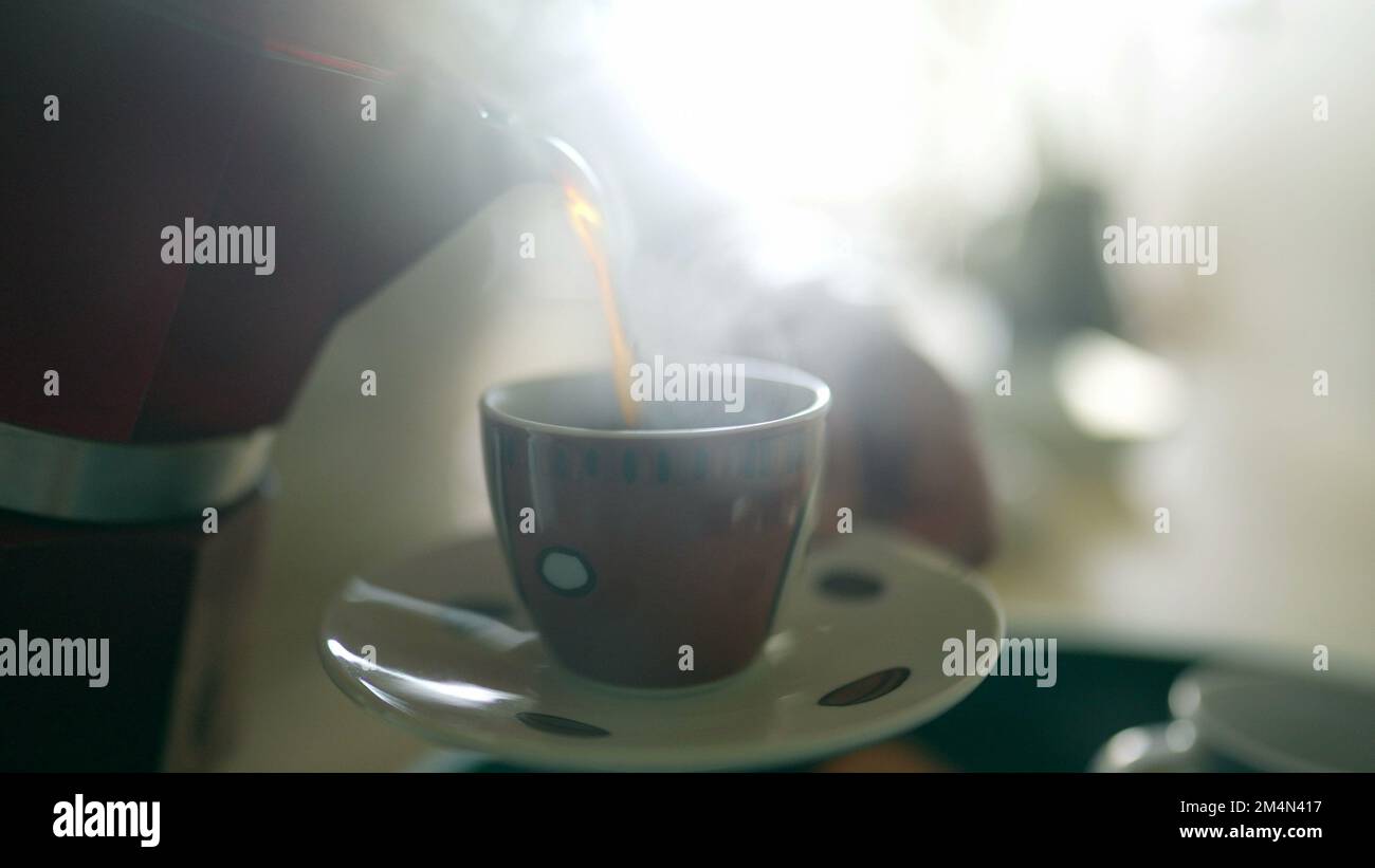 Cup of coffee closeup serving cafe into espresso cup. Morning breakfast ...