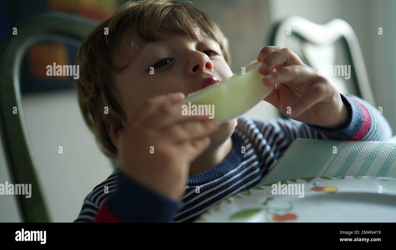 Child eating melon fruit hungry little boy eats healthy snack Stock ...