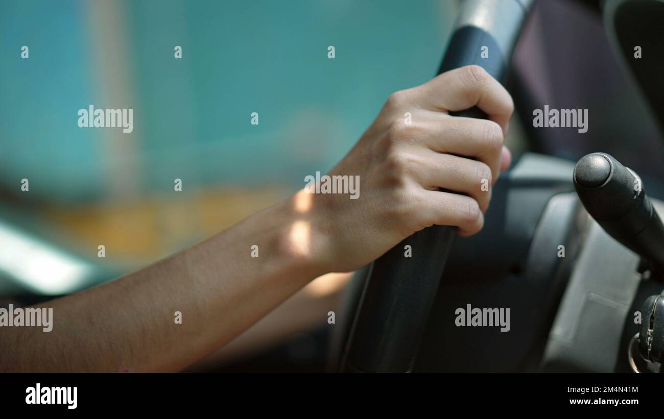 Closeup of person hands on steering wheel driving car. Woman driving a ...