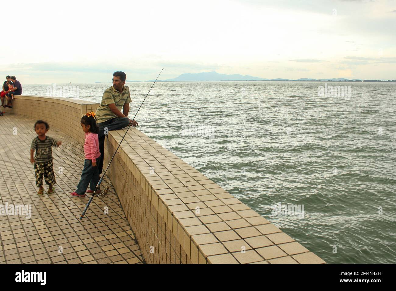 Georgetown, Penang, Malaysia - November 2012: A man and two girls ...