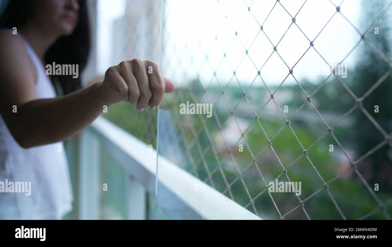 Person opening apartment window. Woman sliding glass at terrace letting ...