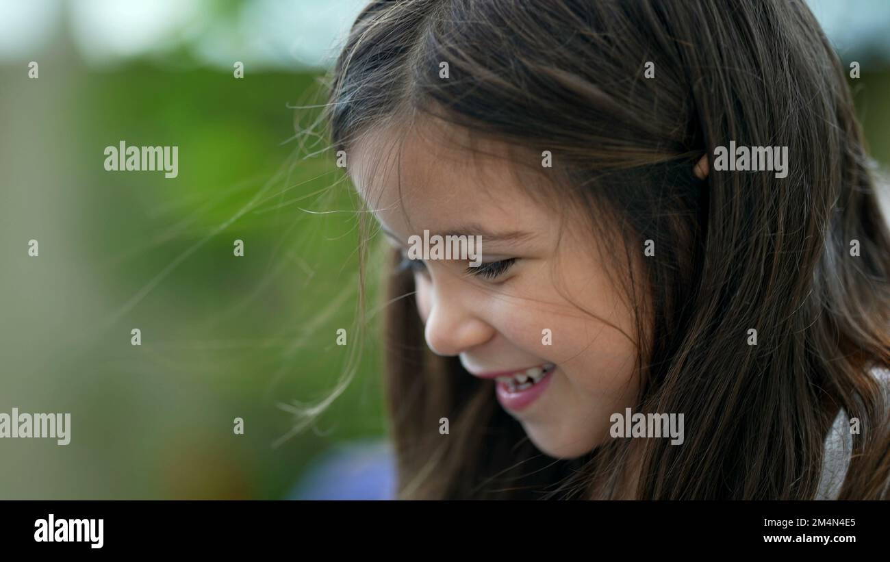 Portrait of a happy little girl closeup face with missing teeth. Joyful ...