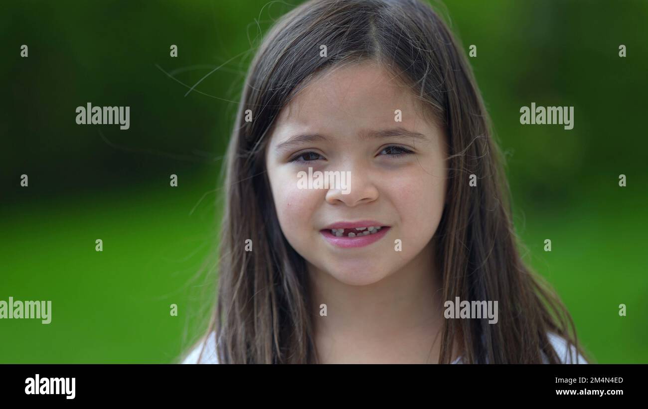 Portrait child with missing teeth smiling at camera Stock Photo - Alamy