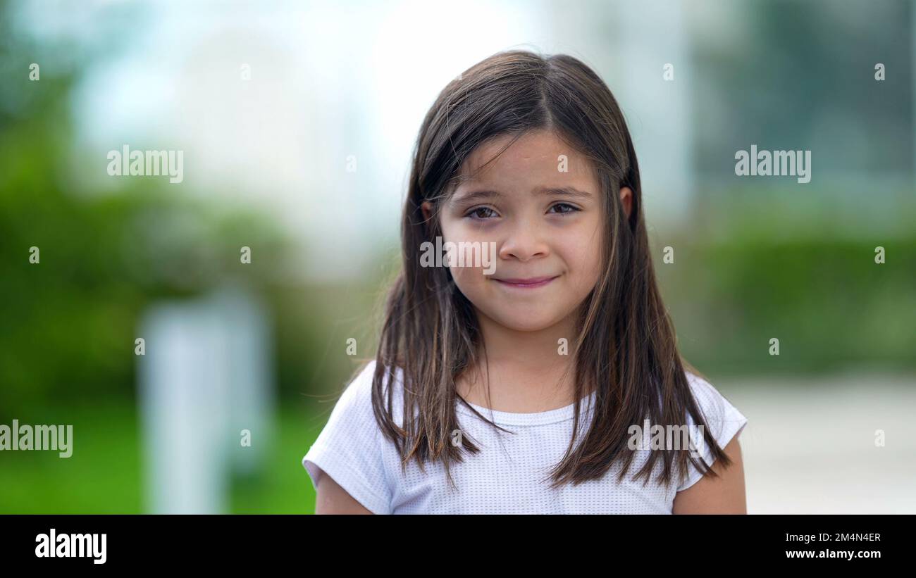 Portrait of little girl smiling female child face closeup looking at ...