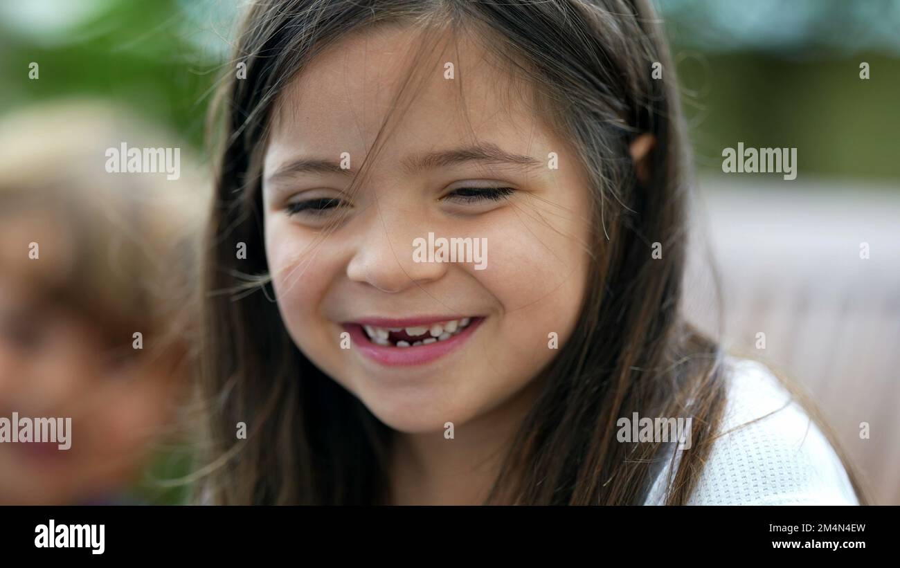 Portrait of a happy little girl closeup face with missing teeth. Joyful ...