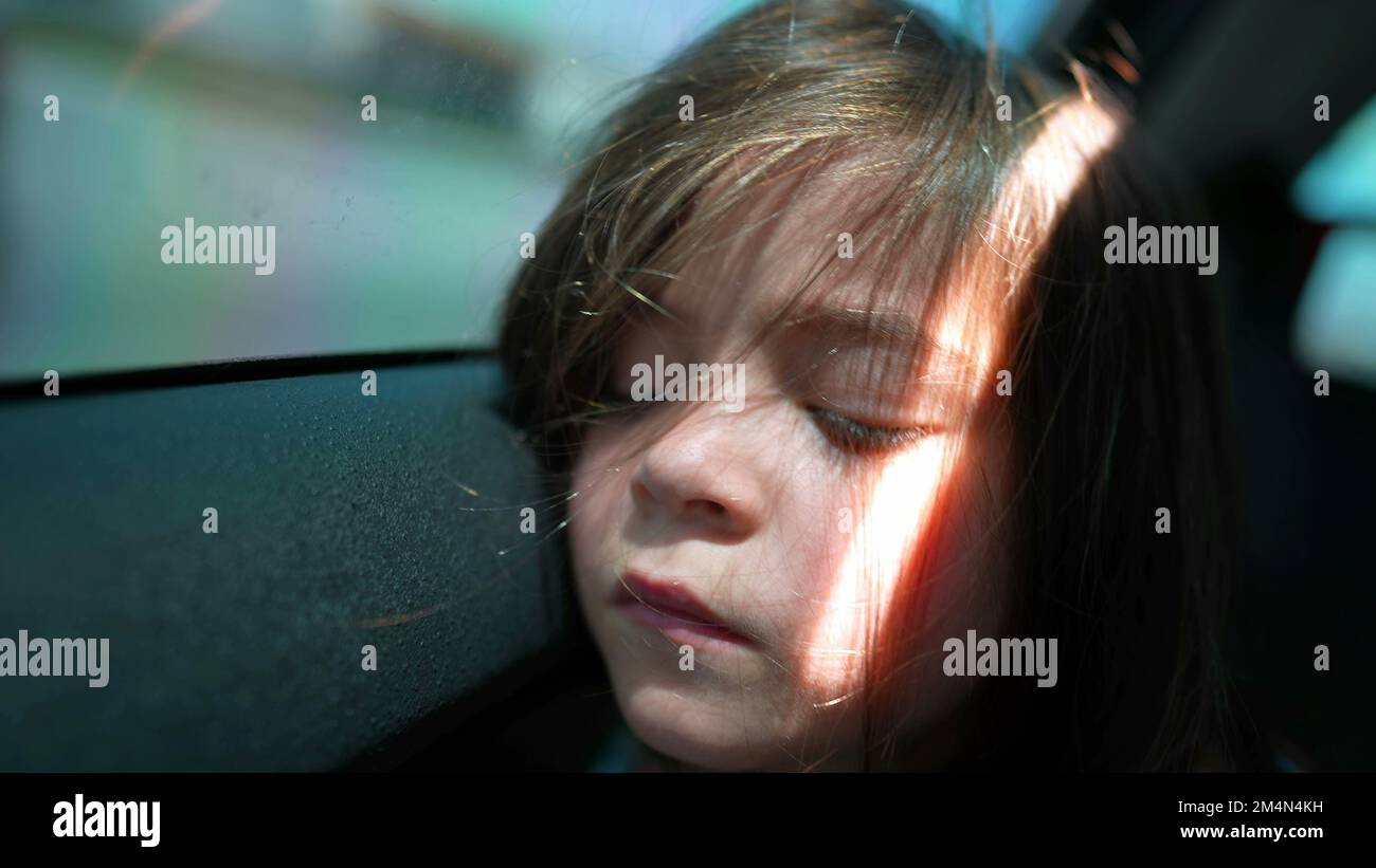 Small girl child closing eyes while traveling by car transportation ...